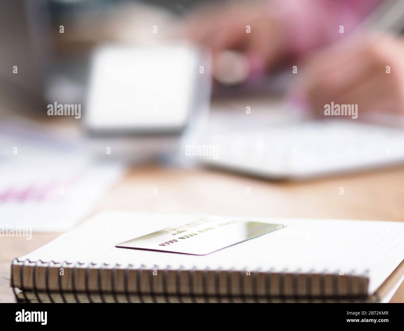 Table in bank notepad with spring and credit card Stock Photo - Alamy