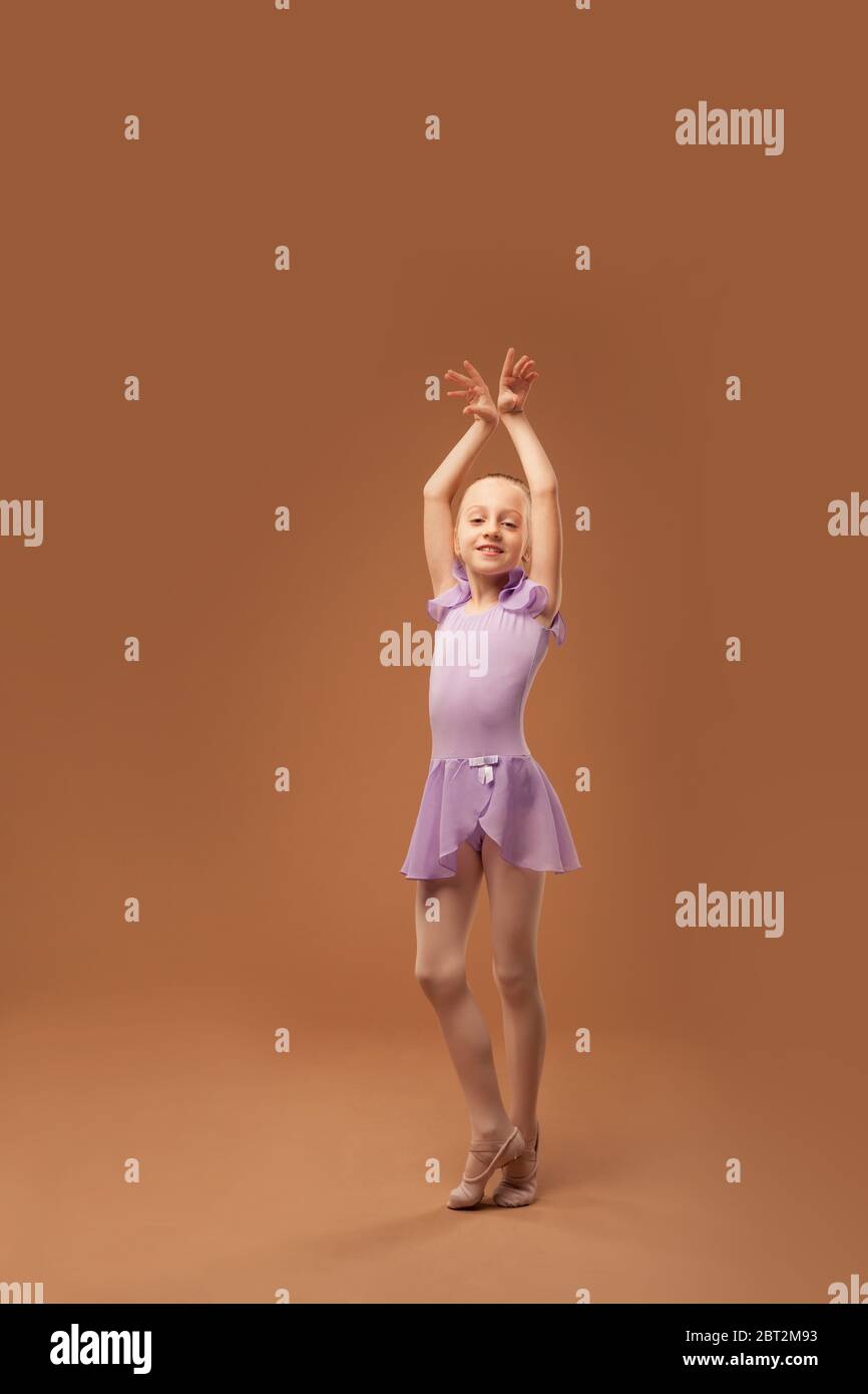 girl in a purple dress shows elements of ballet Stock Photo - Alamy