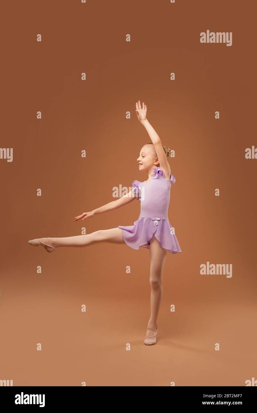 girl in a purple dress shows elements of ballet Stock Photo - Alamy
