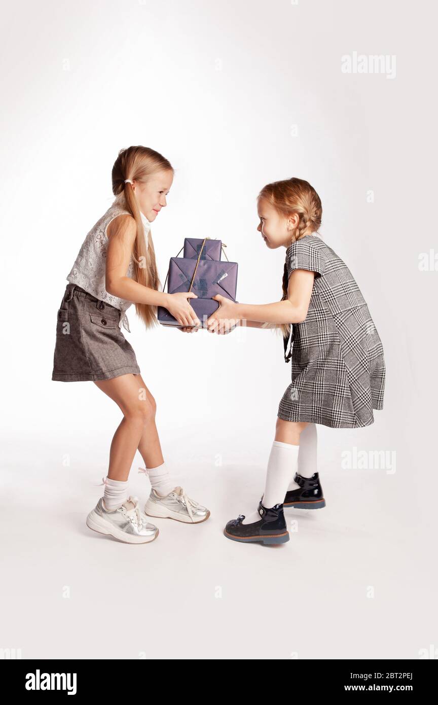 two girls are fighting for boxes with gifts Stock Photo - Alamy