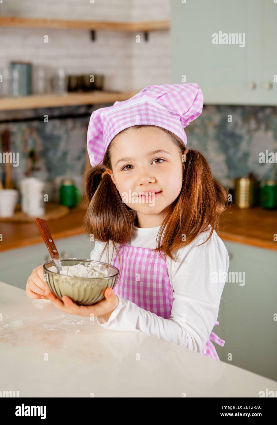 girl in the kitchen is cooking Stock Photo - Alamy
