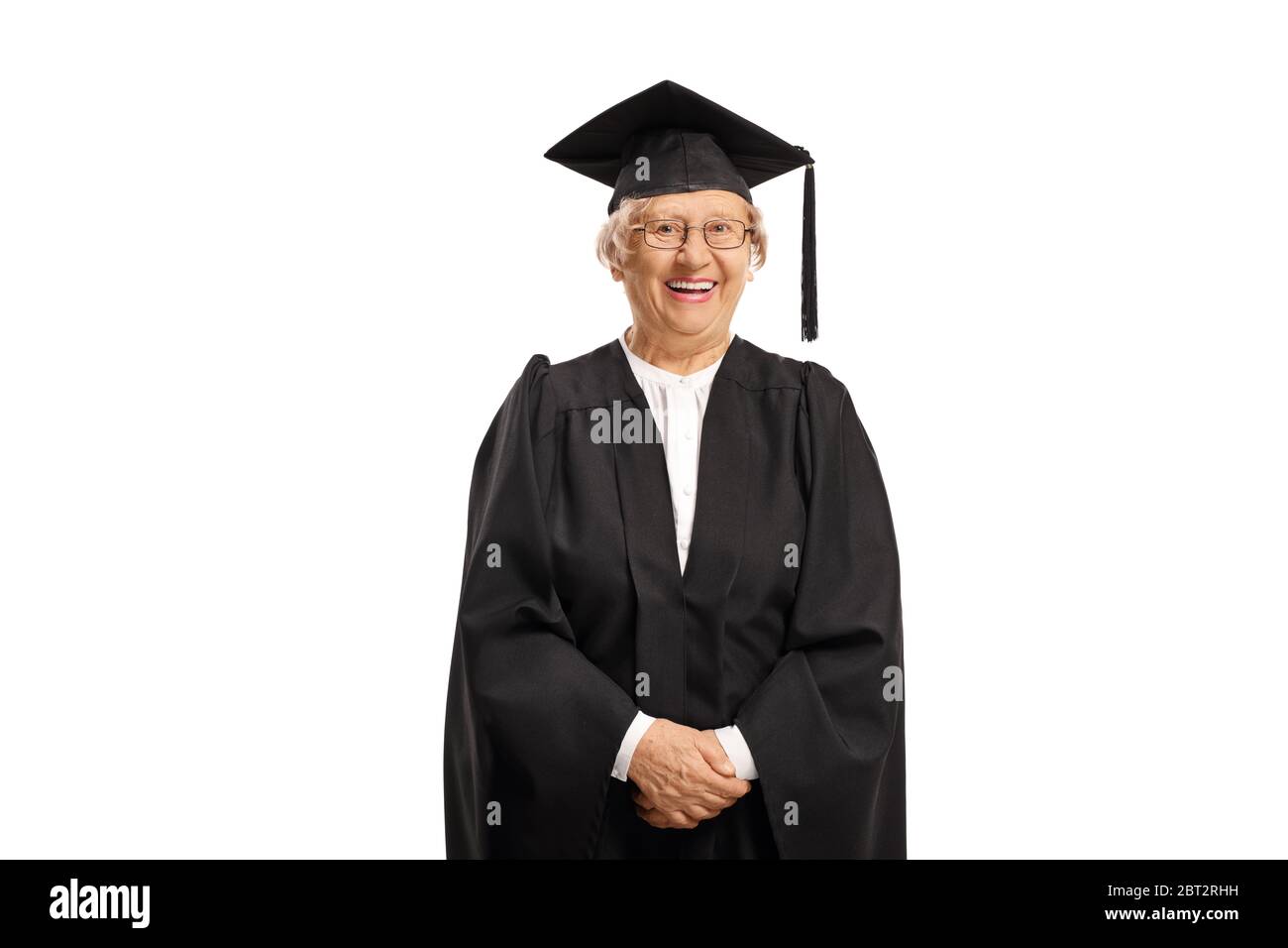 Elderly female graduate wearing a gown and smiling isolated on white ...