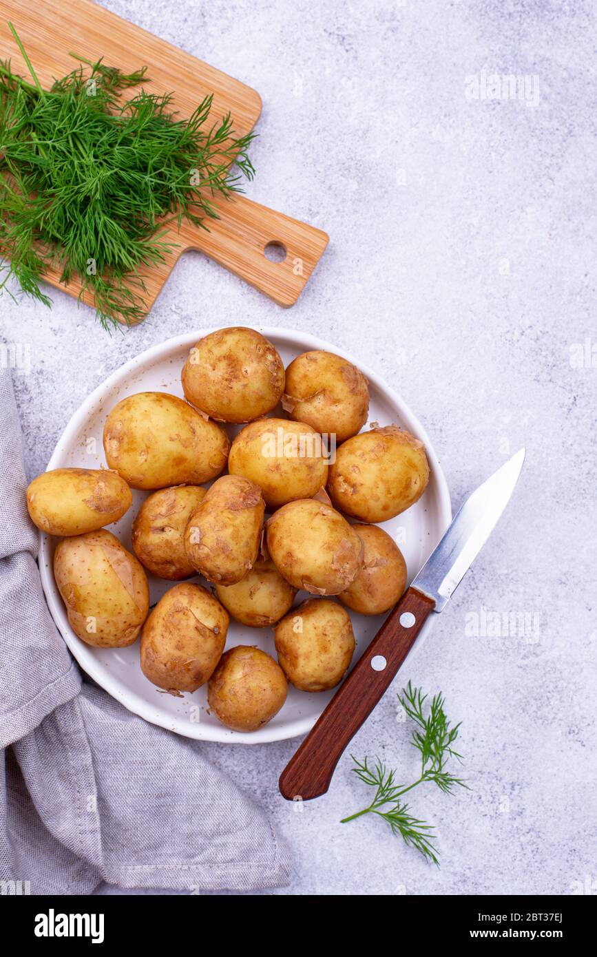 Young uncooked fresh potato and dill Stock Photo - Alamy