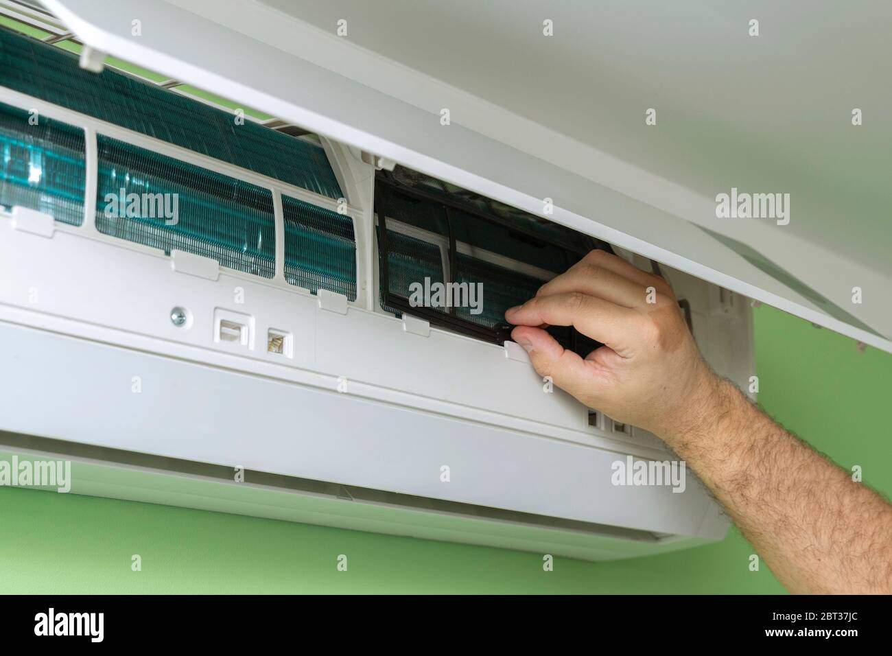 Male technician repairing and reading air conditioners. Opening the ...