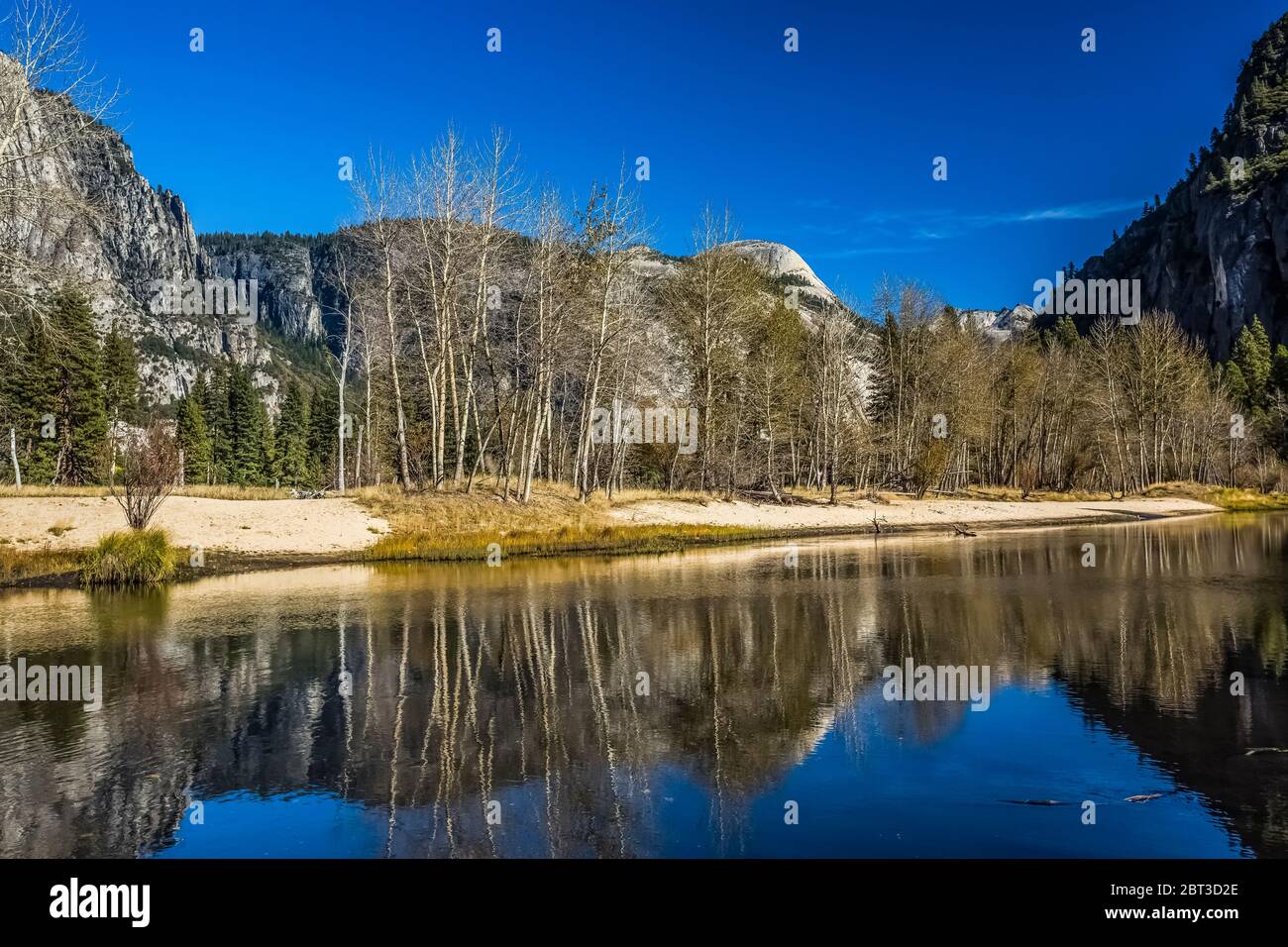 The Merced River flowing peacefully along the floor of Yosemite Valley ...