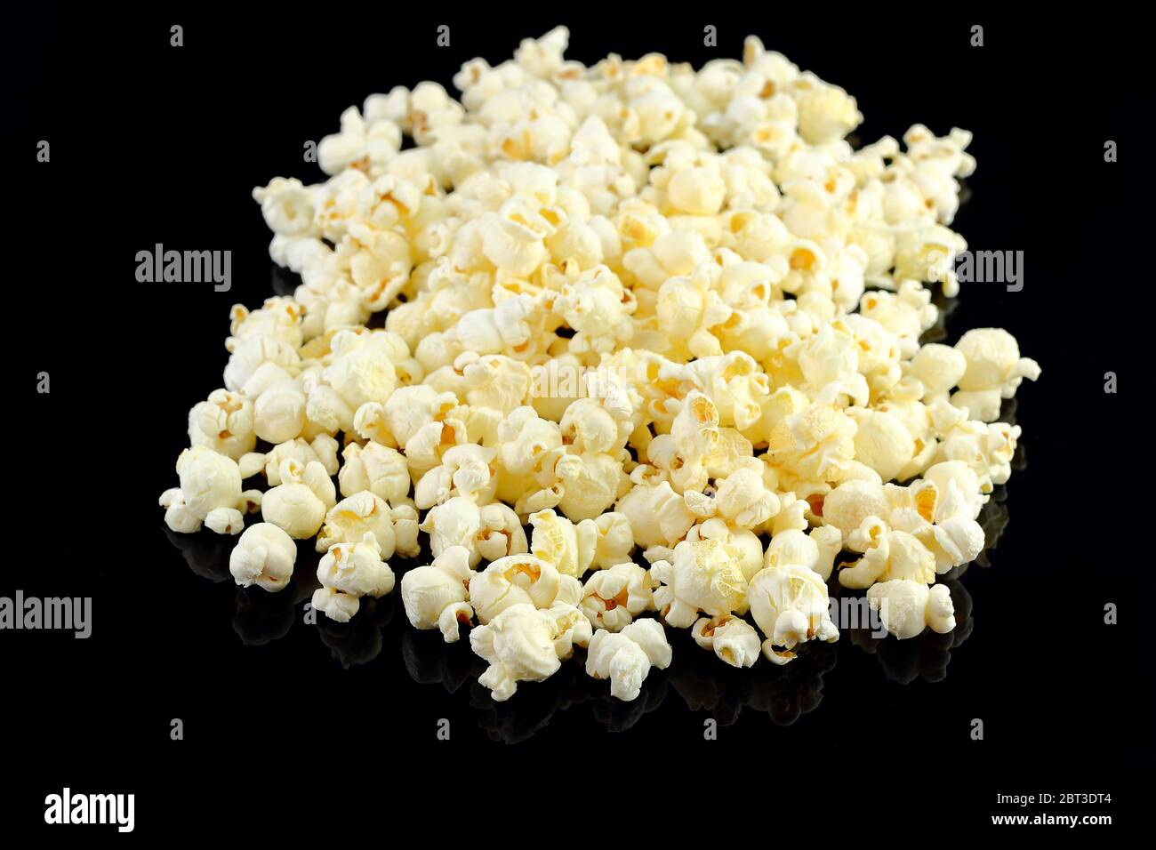 Popcorn pile on black background Stock Photo - Alamy