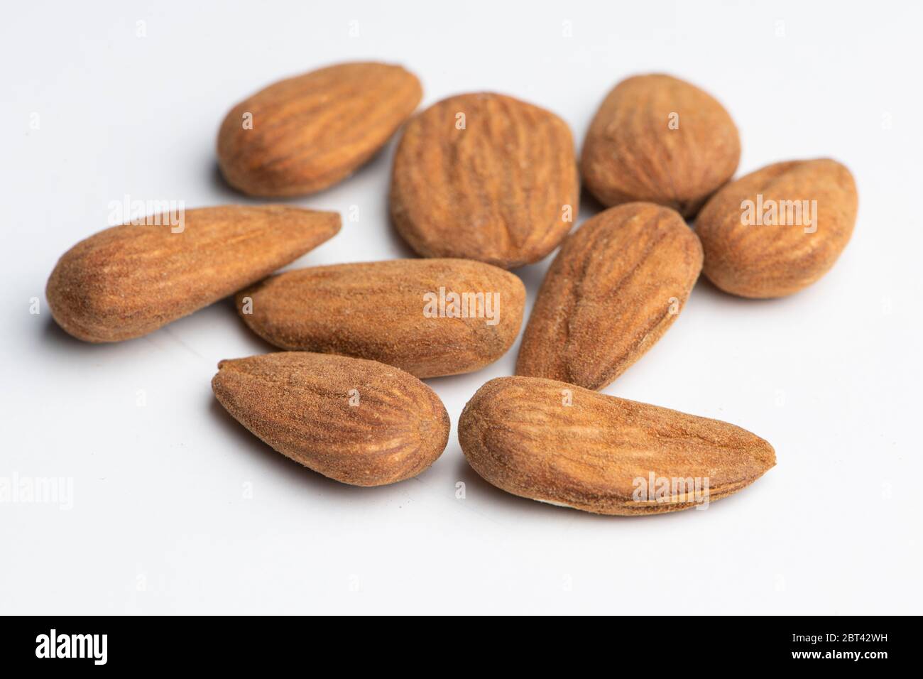 Many fresh and tasty Almonds on a white background Stock Photo - Alamy