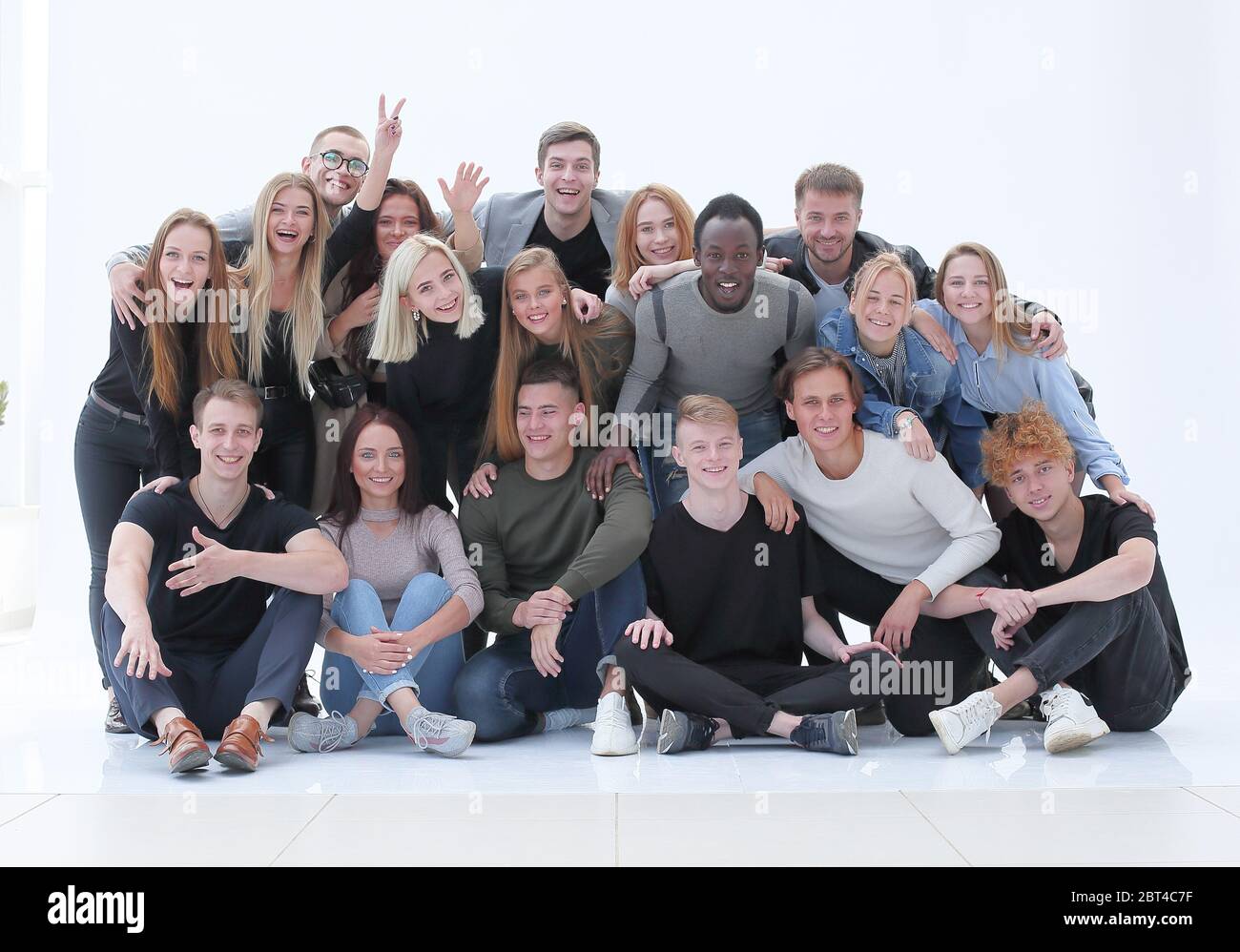 in full growth. a large group of friends gathered together Stock Photo ...