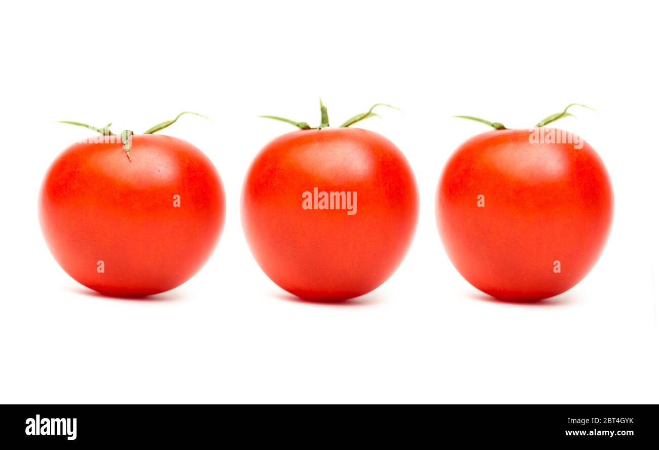 Three red ripe tomatoes isolated on white background Stock Photo - Alamy