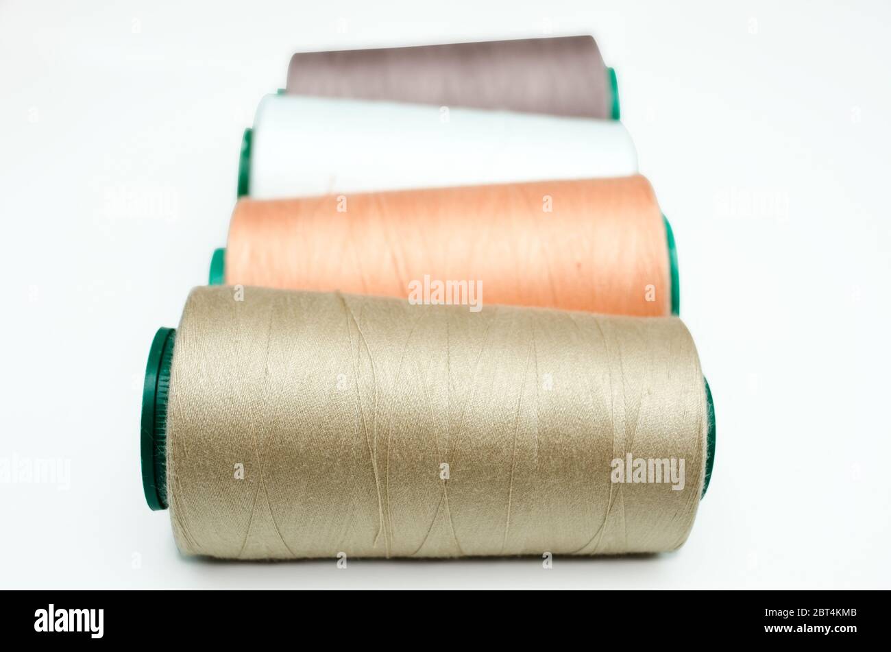Spools of thread various color on a white background Stock Photo - Alamy