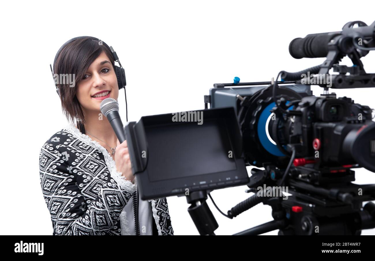 a pretty young woman journalist with microphone and camera on white ...