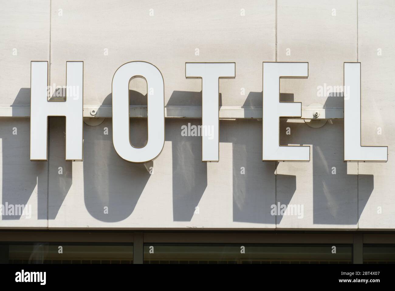 White hotel sign with shadow, Germany, Europe Stock Photo - Alamy