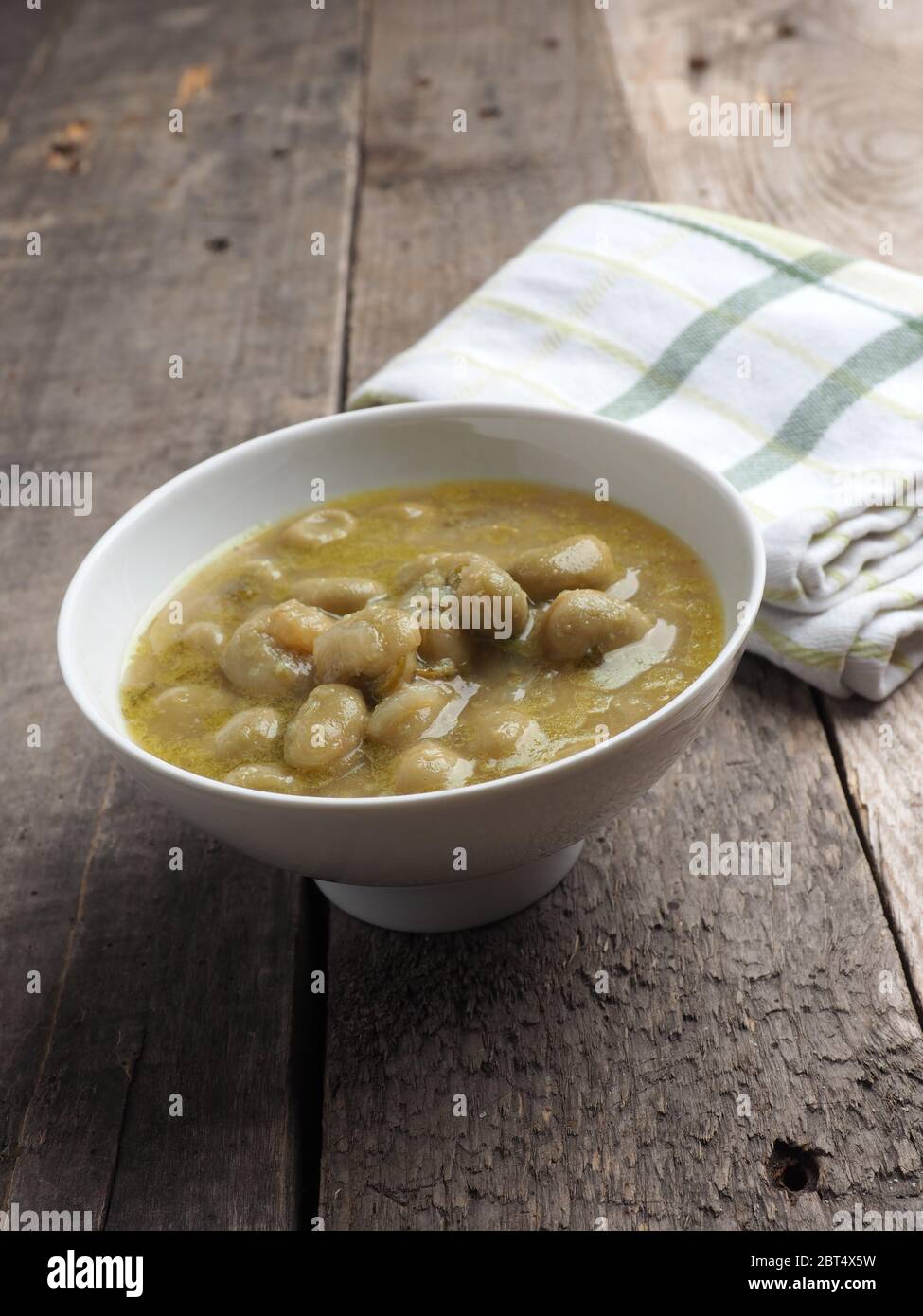 Delicious thick beans in a white bowl on a rustic wooden table Stock ...