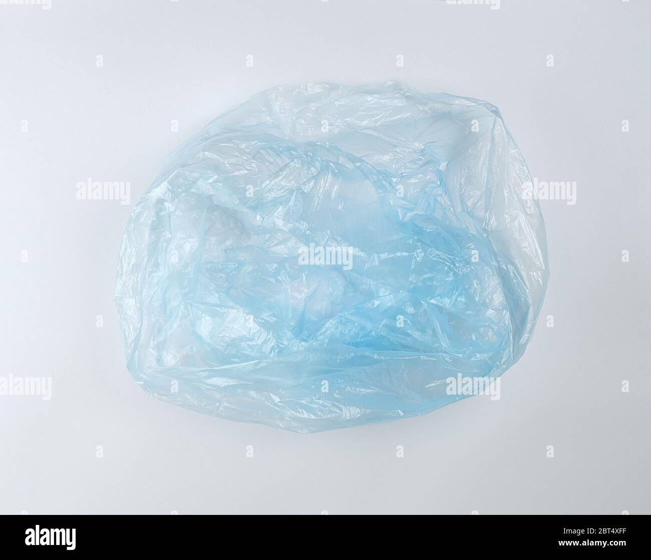 empty blue plastic bag for garbage on a white background, top view ...
