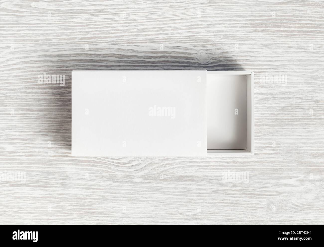 Blank box mock up. White paper box on light wood table background ...