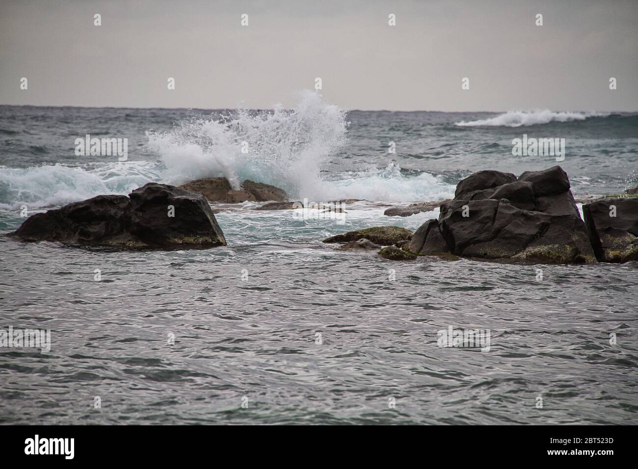 Waves crashing on Rocks Stock Photo - Alamy