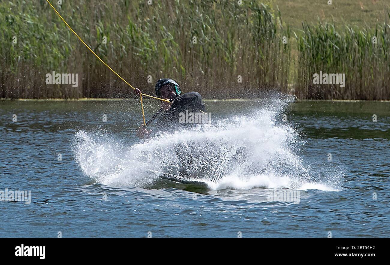 Velten, Germany. 20th May, 2020. A man is on the water ski facility ...