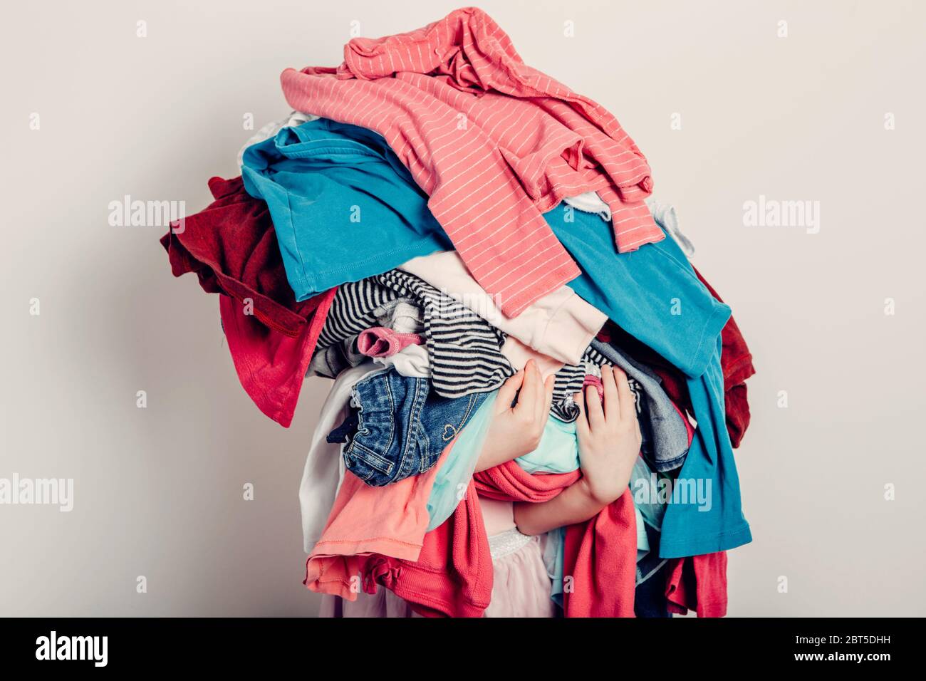 Mommy little helper. Cute Caucasian girl sorting clothes. Adorable ...