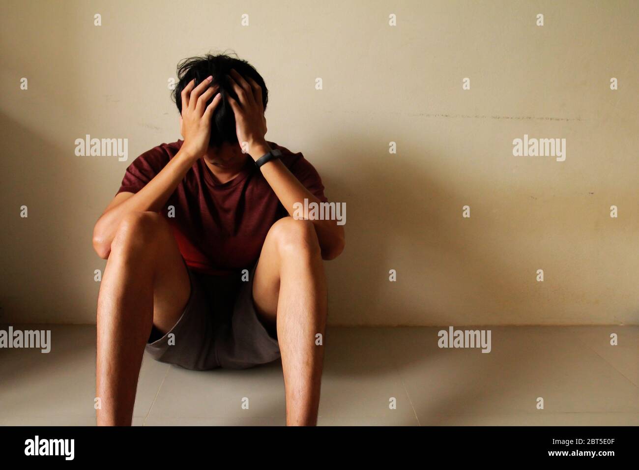 sad young man sitting alone in a empty room, sad ,lonely ,chool ...