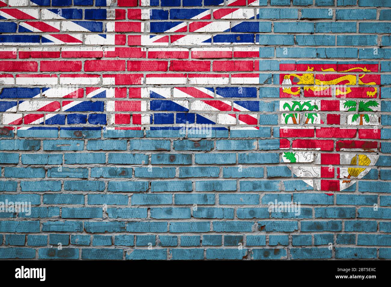 National flag of Fiji depicting in paint colors on an old brick wall ...