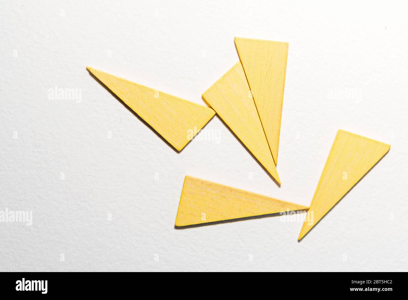 Different colorful triangles wooden on white background. Geometric ...