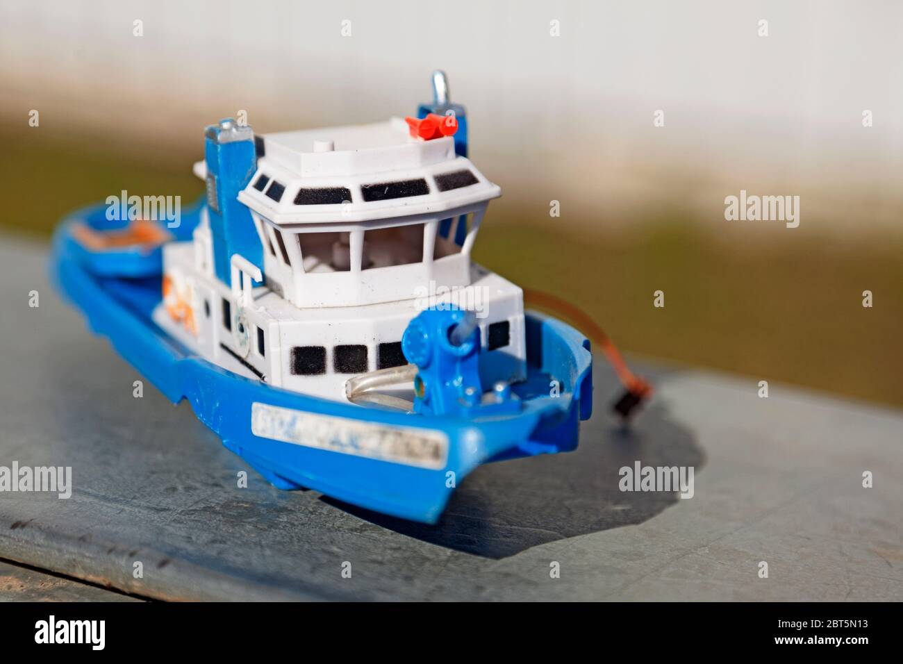 a toy boat in blue and white plastic Stock Photo - Alamy