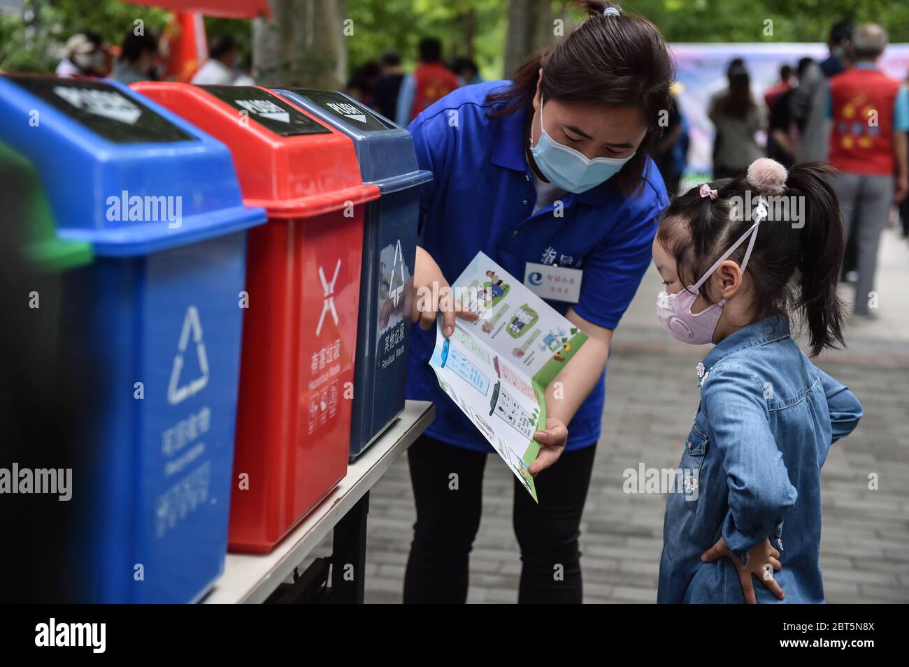 Beijing, China. 23rd May, 2020. A girl learns about garbage sorting ...