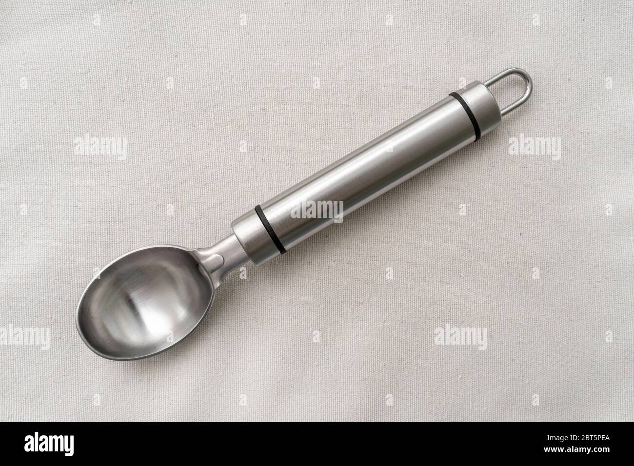 metal ice cream spoon on fabric surface Stock Photo - Alamy