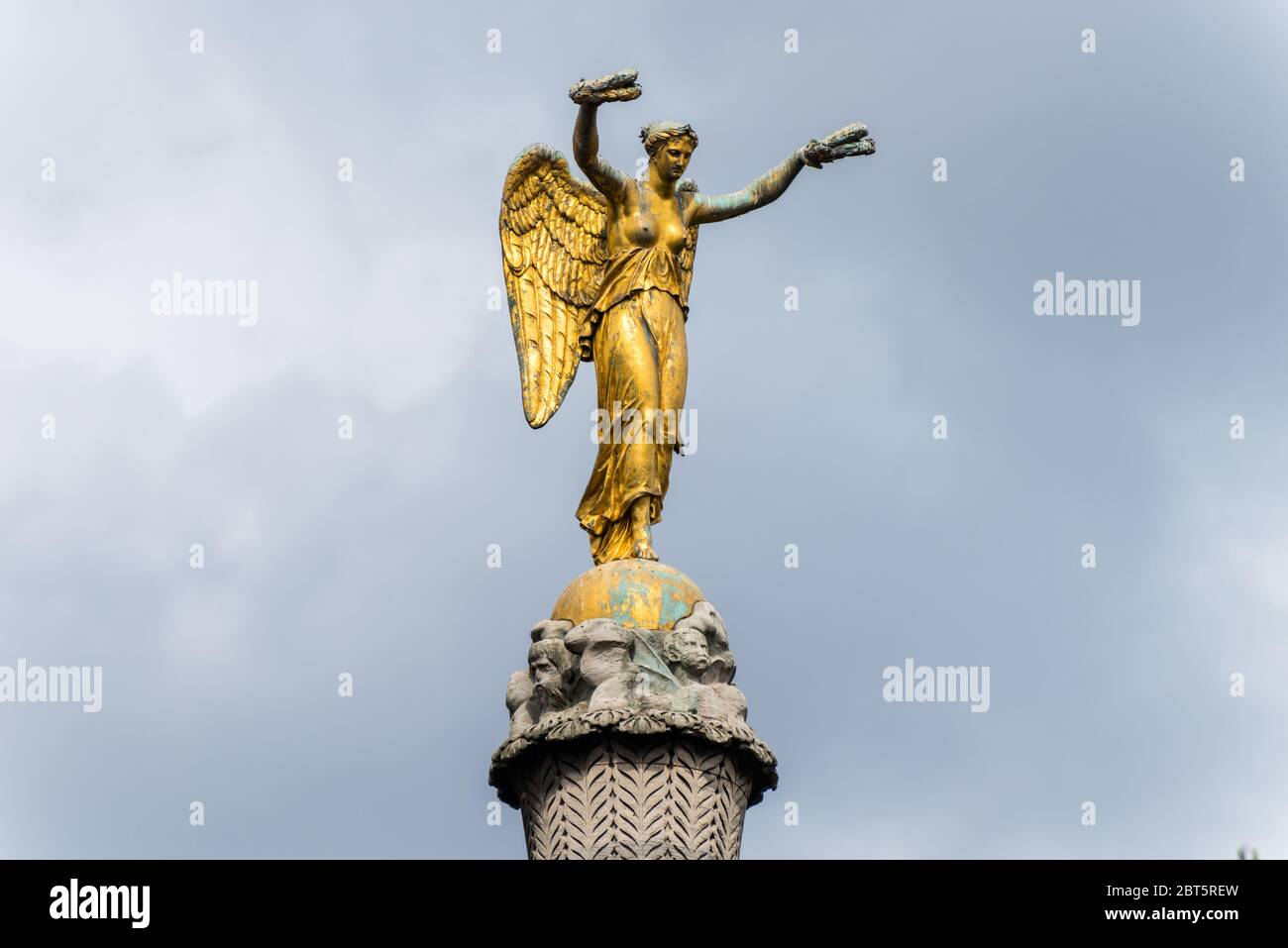 A golden winged statue on the top of a column in the downtown of Paris ...