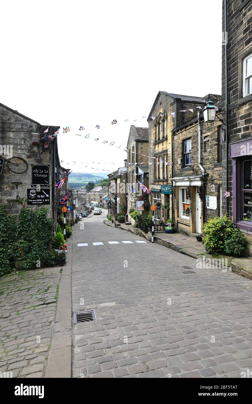 The view looking down the cobbled main street in Haworth, West ...