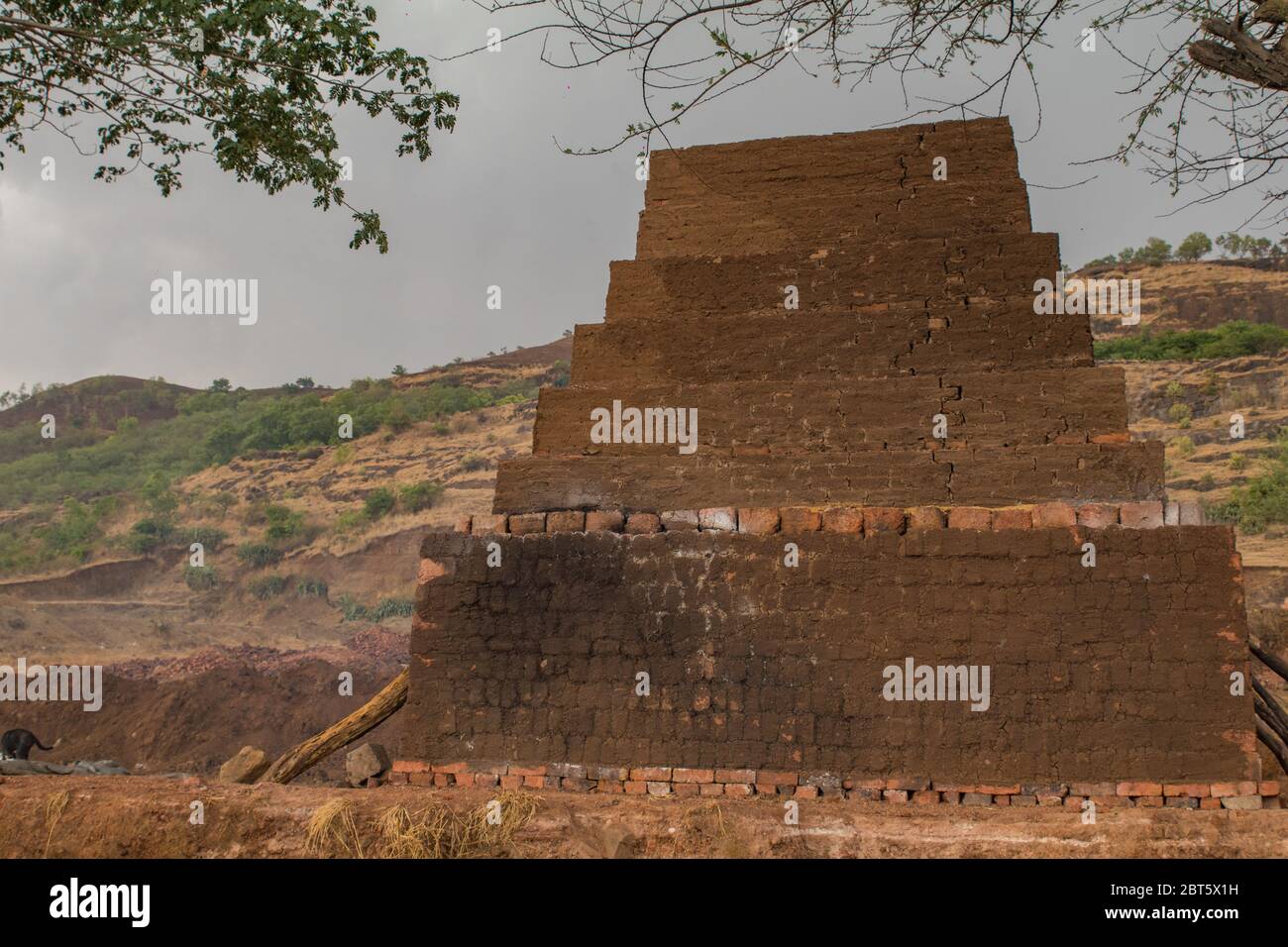 a brick kiln from a remote village in India. Raw bricks arranged in ...