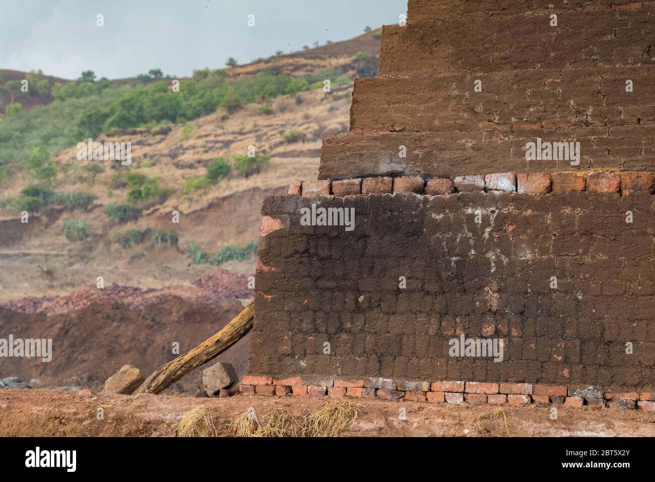 close up photo of a brick kiln. stepped pyramid of smoky raw and mud ...