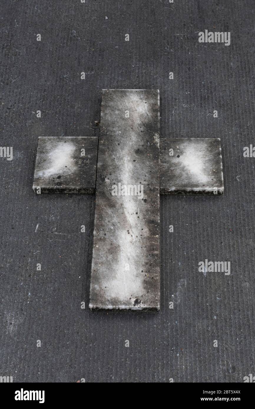 Concrete cross with white mold on a gray concrete background Stock ...