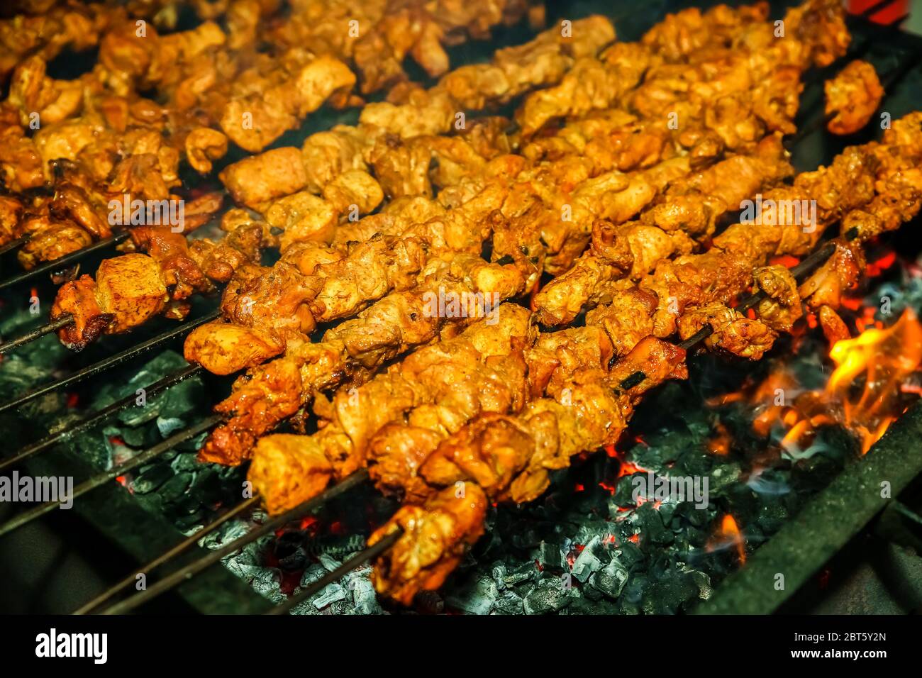 Chicken Sekuwa, Grilled chicken meat on charcoal with skewers Stock ...