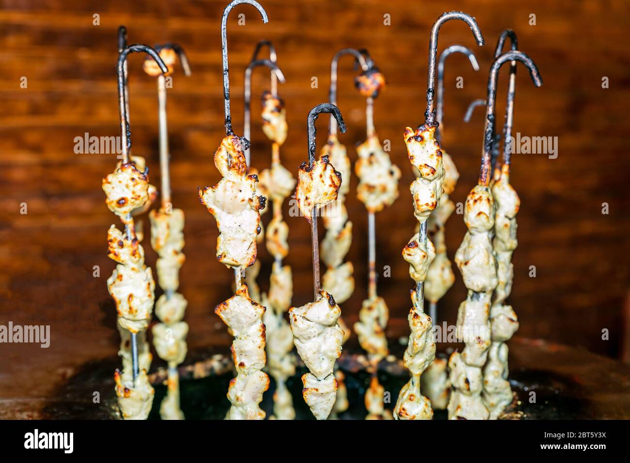 Chicken Sekuwa, Grilled chicken meat on charcoal with skewers Stock ...