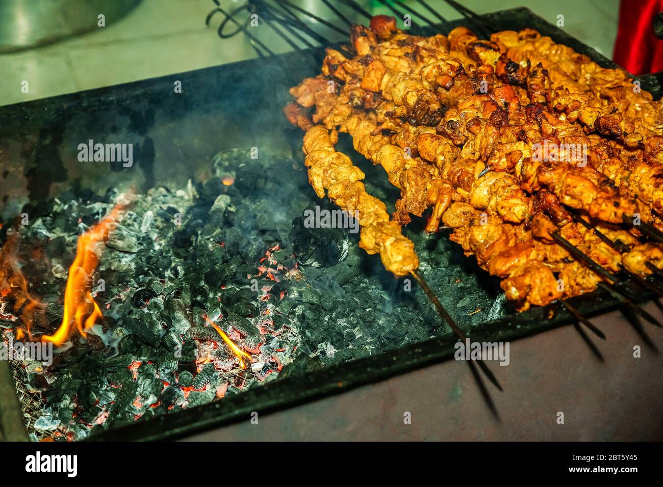 Chicken Sekuwa, Grilled chicken meat on charcoal with skewers Stock ...