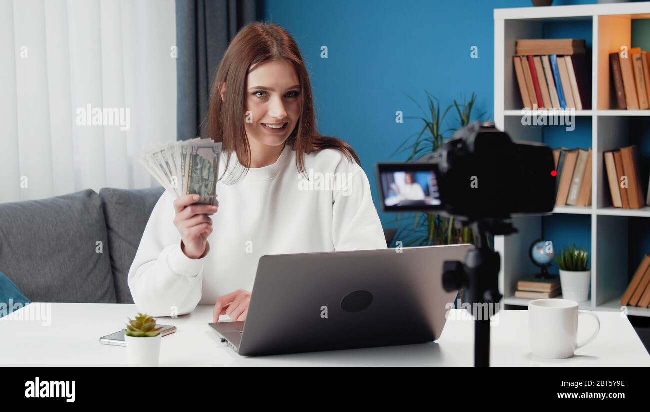 Lady showing money filming vlog Stock Photo - Alamy