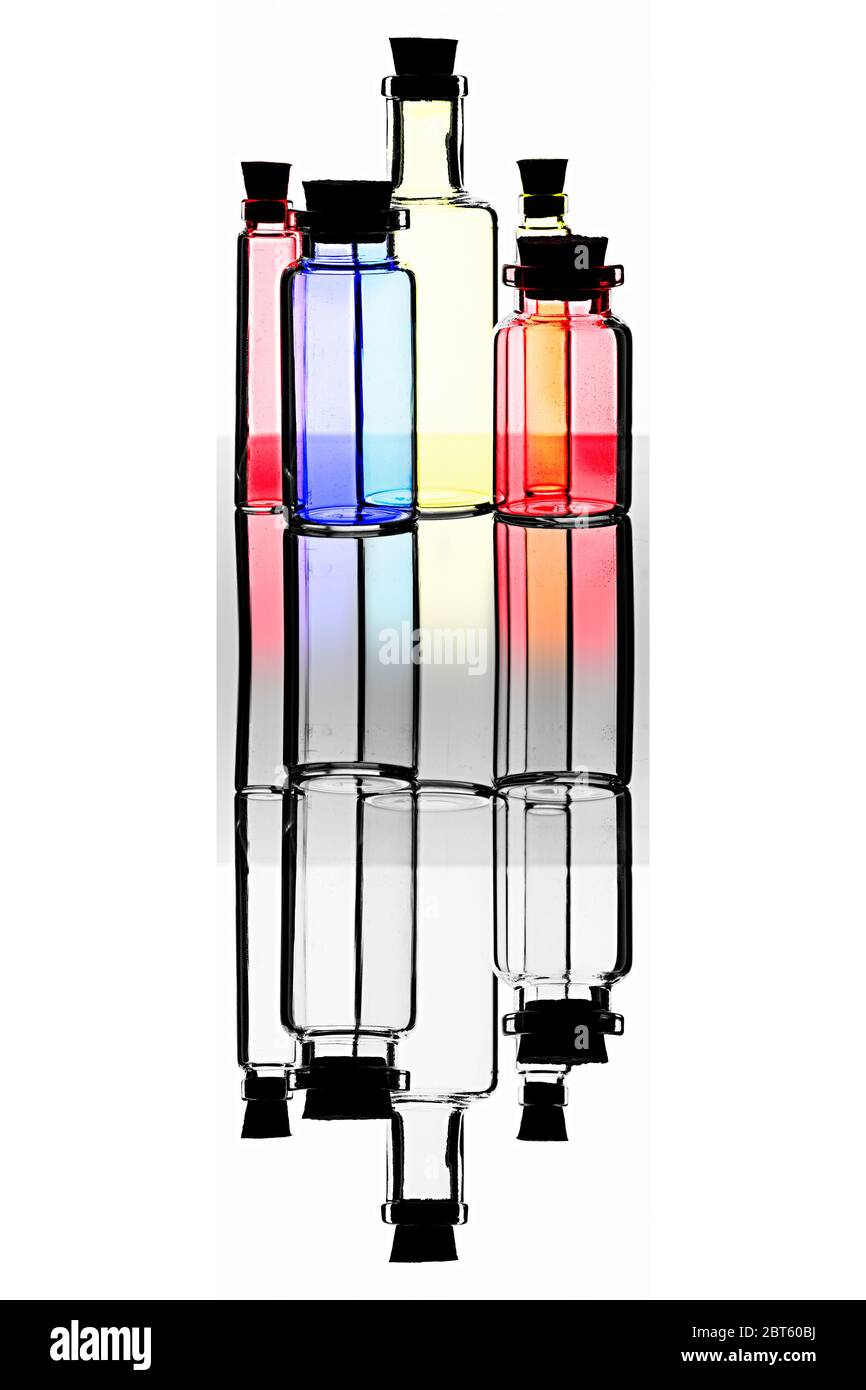 Coloured glass bottled, fading to monochrome in their reflection Stock ...