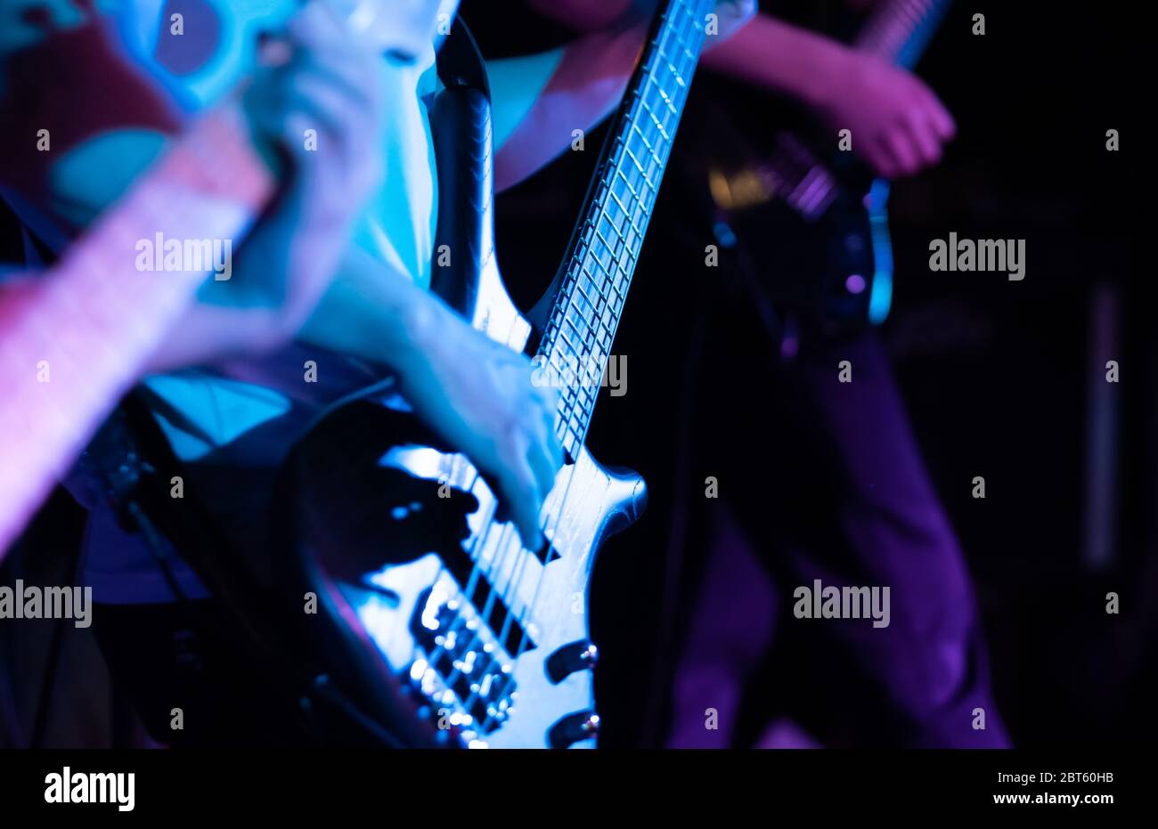 Great performing on four string bass guitar at rock concert Stock Photo ...