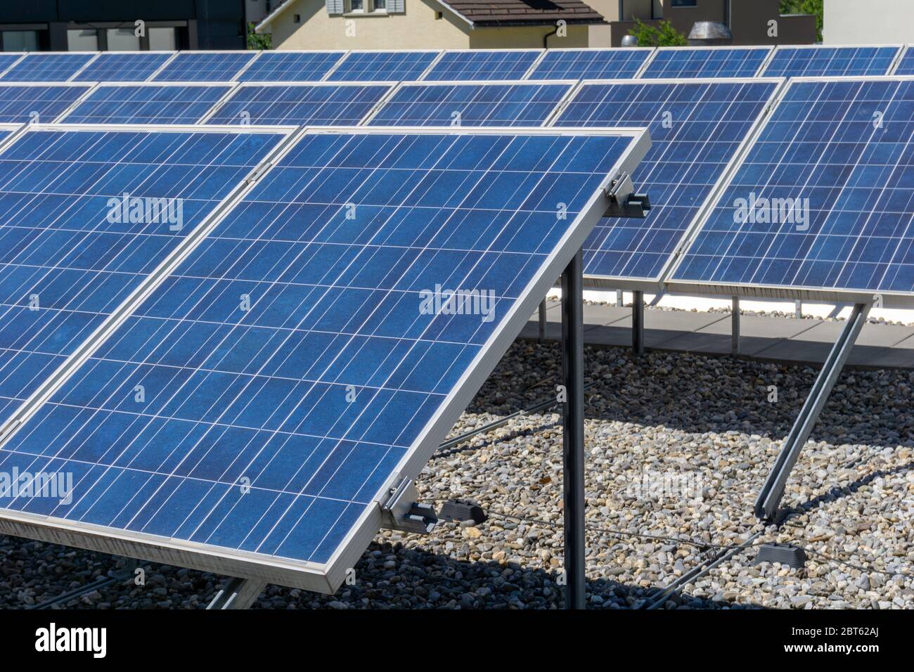 A close up view of a row of modern solar panels on a flat rooftop Stock ...