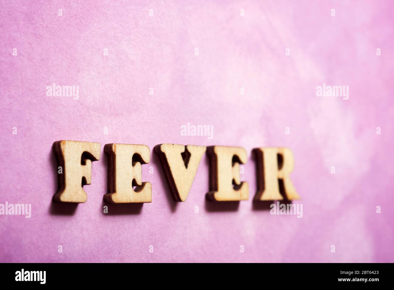 Fever text on a colored paper Stock Photo - Alamy