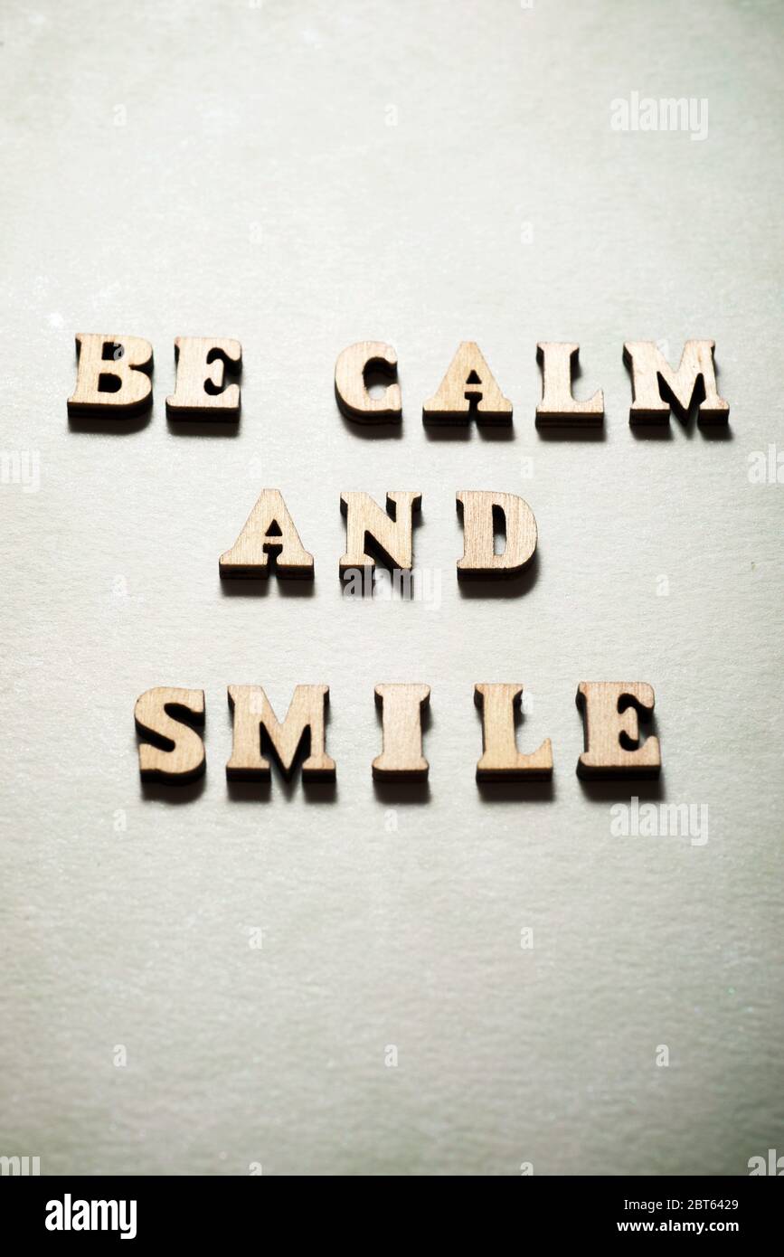 Be calm and smile text in a colored paper Stock Photo - Alamy