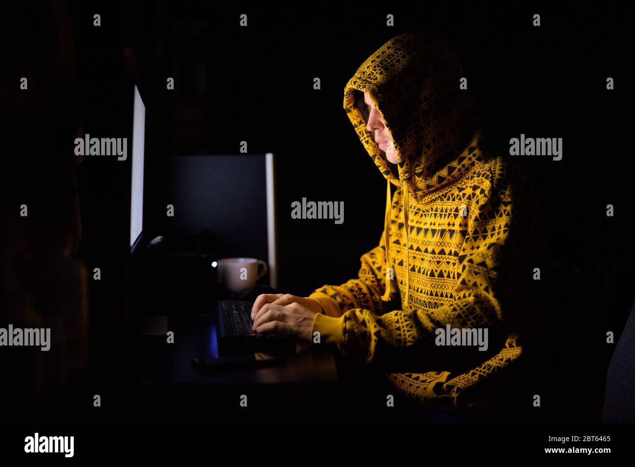 Man at desk wearing hoodie hi-res stock photography and images - Alamy