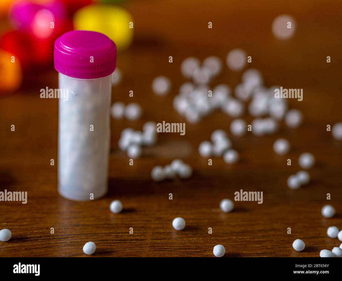 Bottles of homeopathic pills/globules with wooden brown background ...