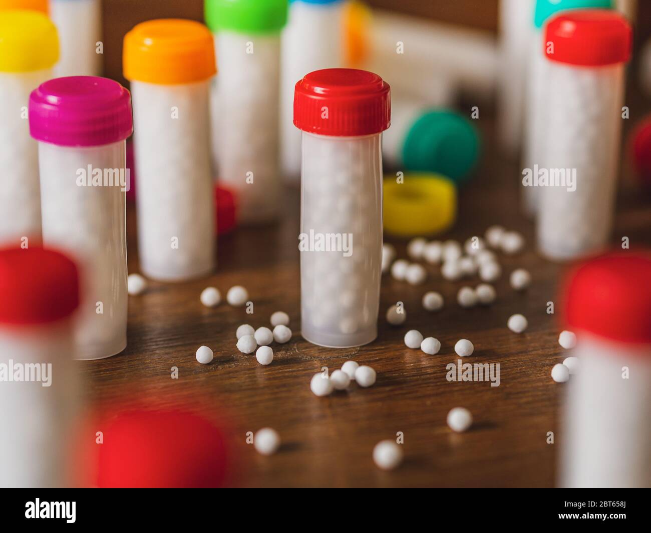 Colorful plastic Bottles filled with white homeopathic pills/globules ...