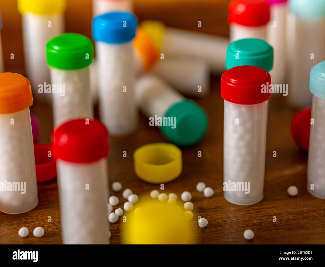 Colorful plastic Bottles filled with white homeopathic pills/globules ...