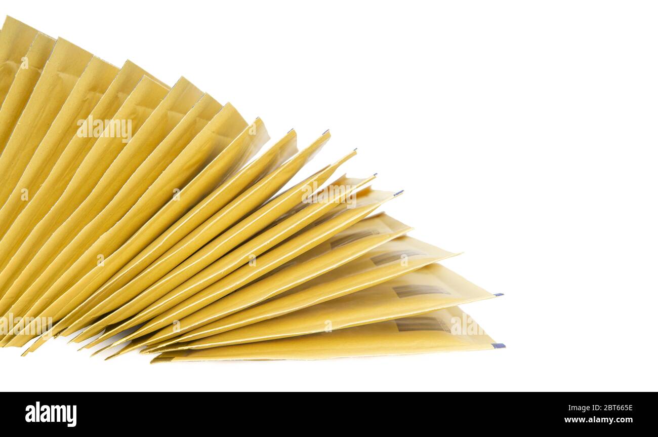 A pile of yellow shipping envelopes isolated on white Stock Photo - Alamy