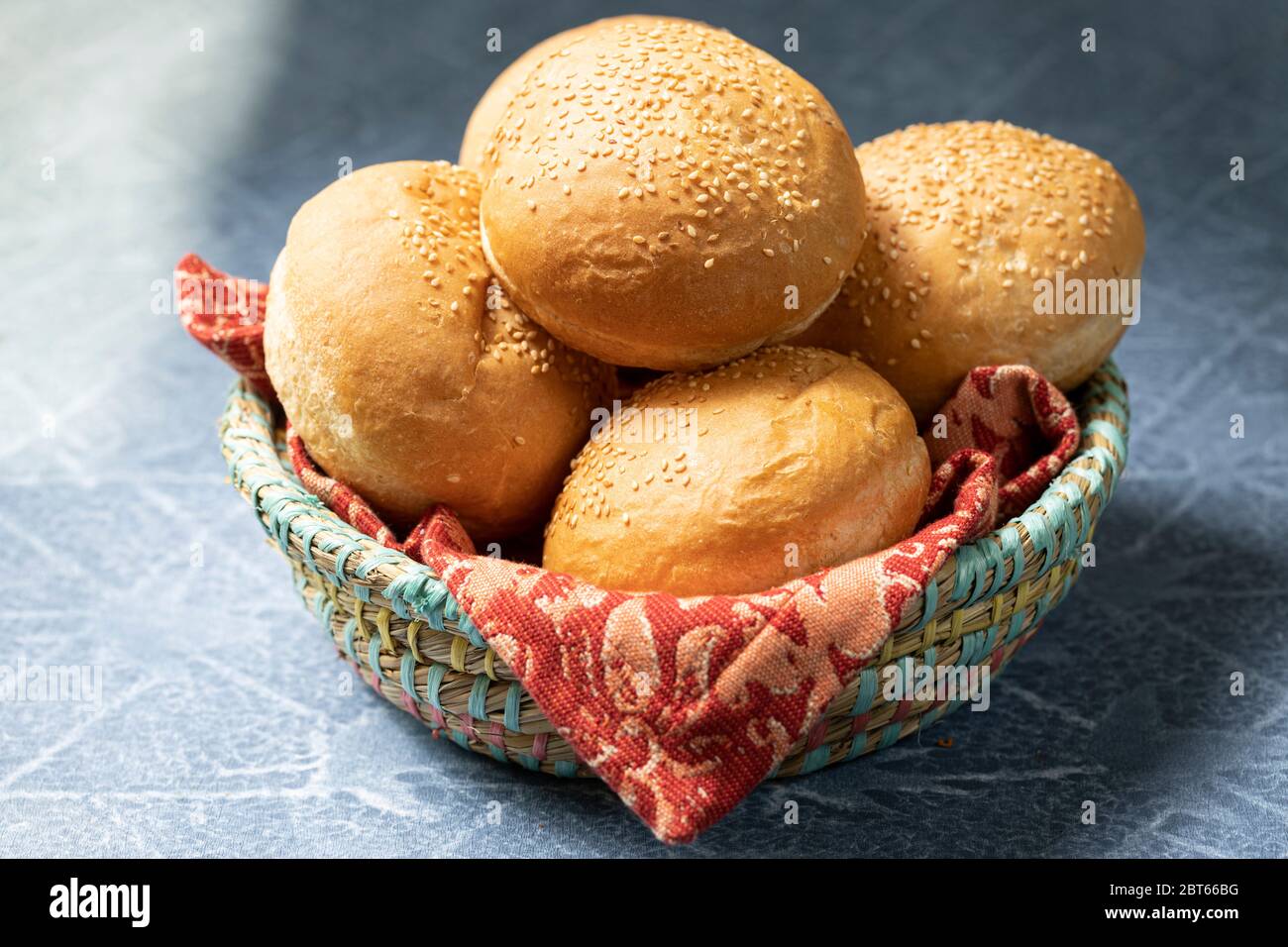 Zaatar seeds drizzled bun in a cane basket Stock Photo - Alamy