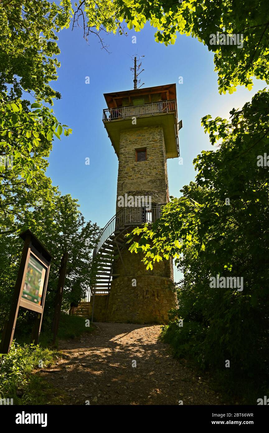 Beautiful stone lookout tower in the forest with trees and blue sky and ...