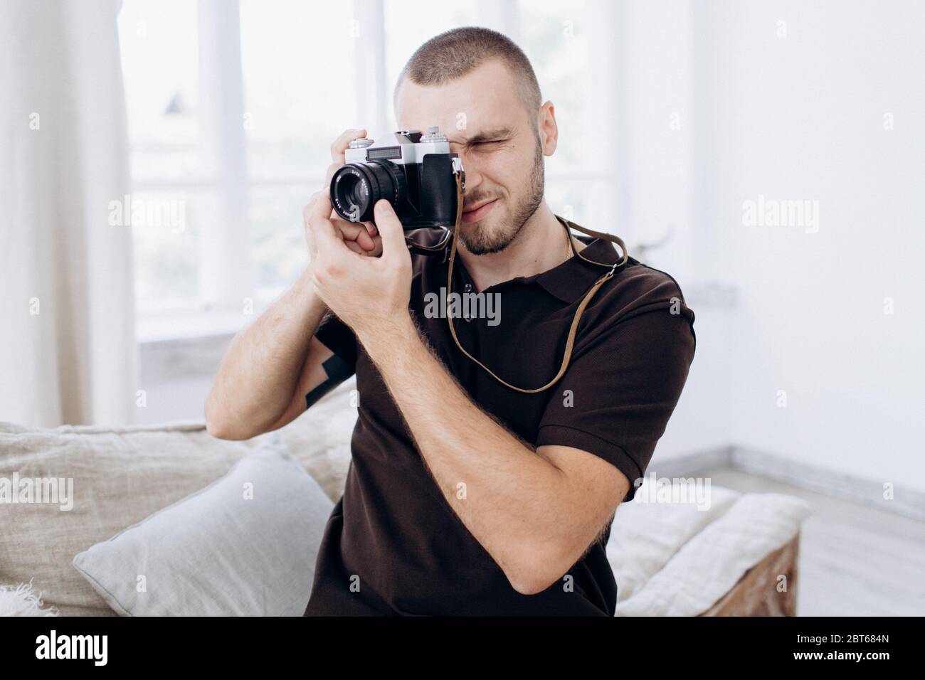 Young guy photographer holding a camera. Learning photography Stock ...
